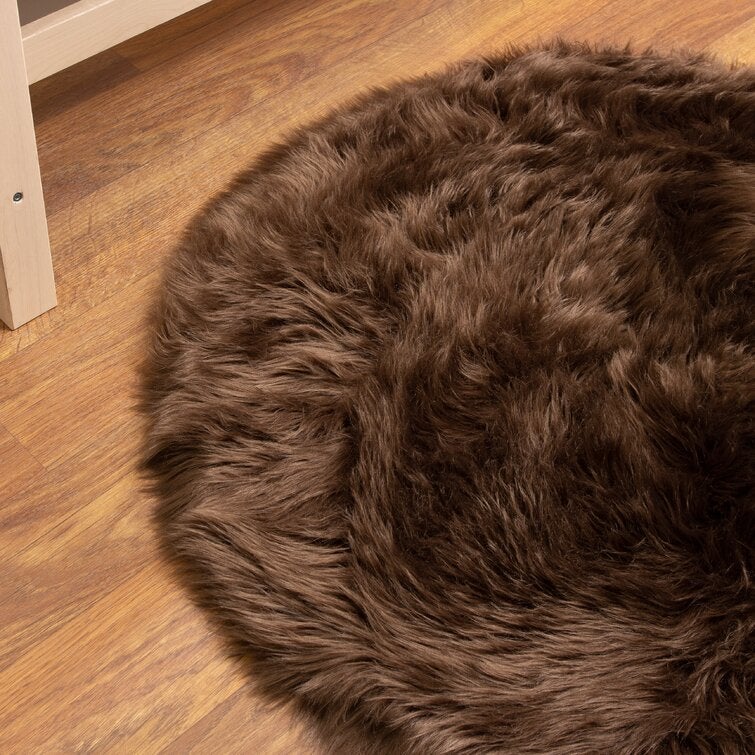 Union Rustic + Seppe Shag Faux Sheepskin Area Rug in Dark Brown